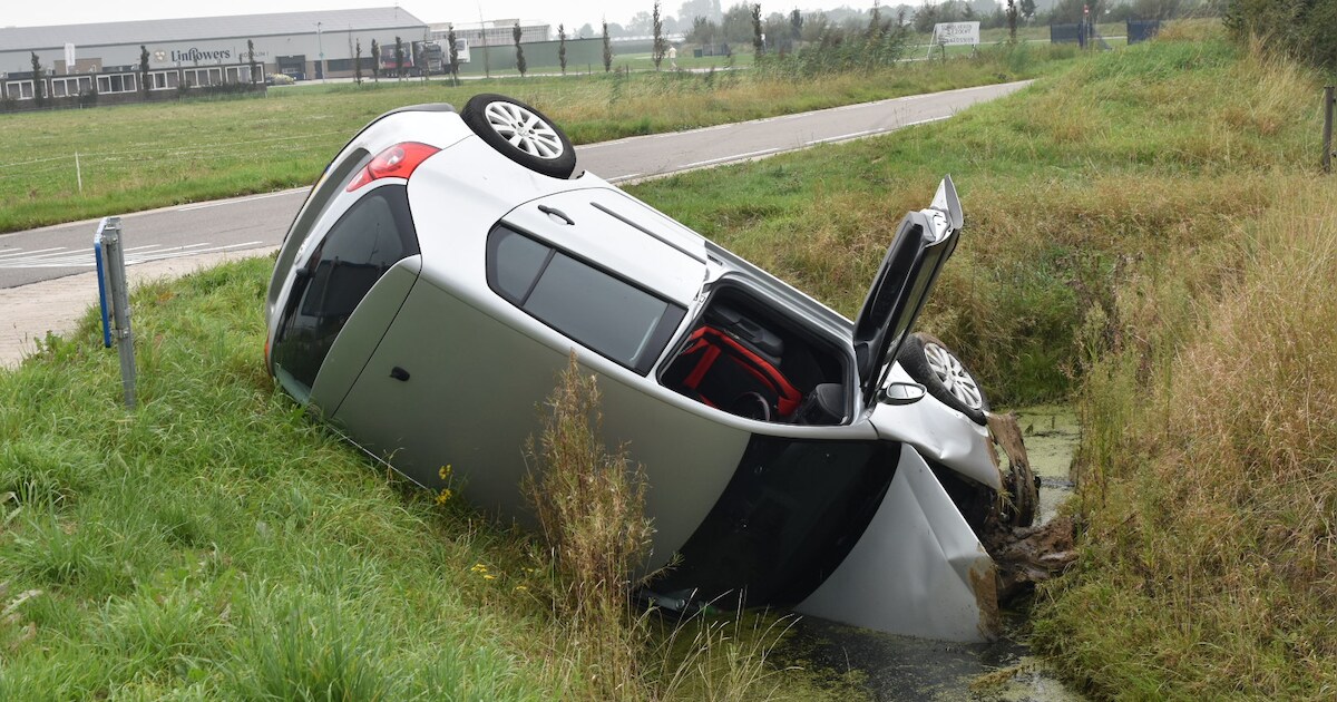 Auto rijdt van weg af en belandt half ondersteboven in sloot ...